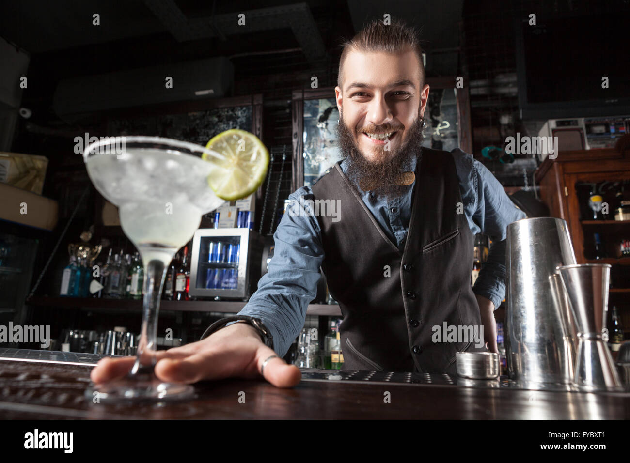 This is a photograph of barman serving cocktail margarita Stock Photo ...