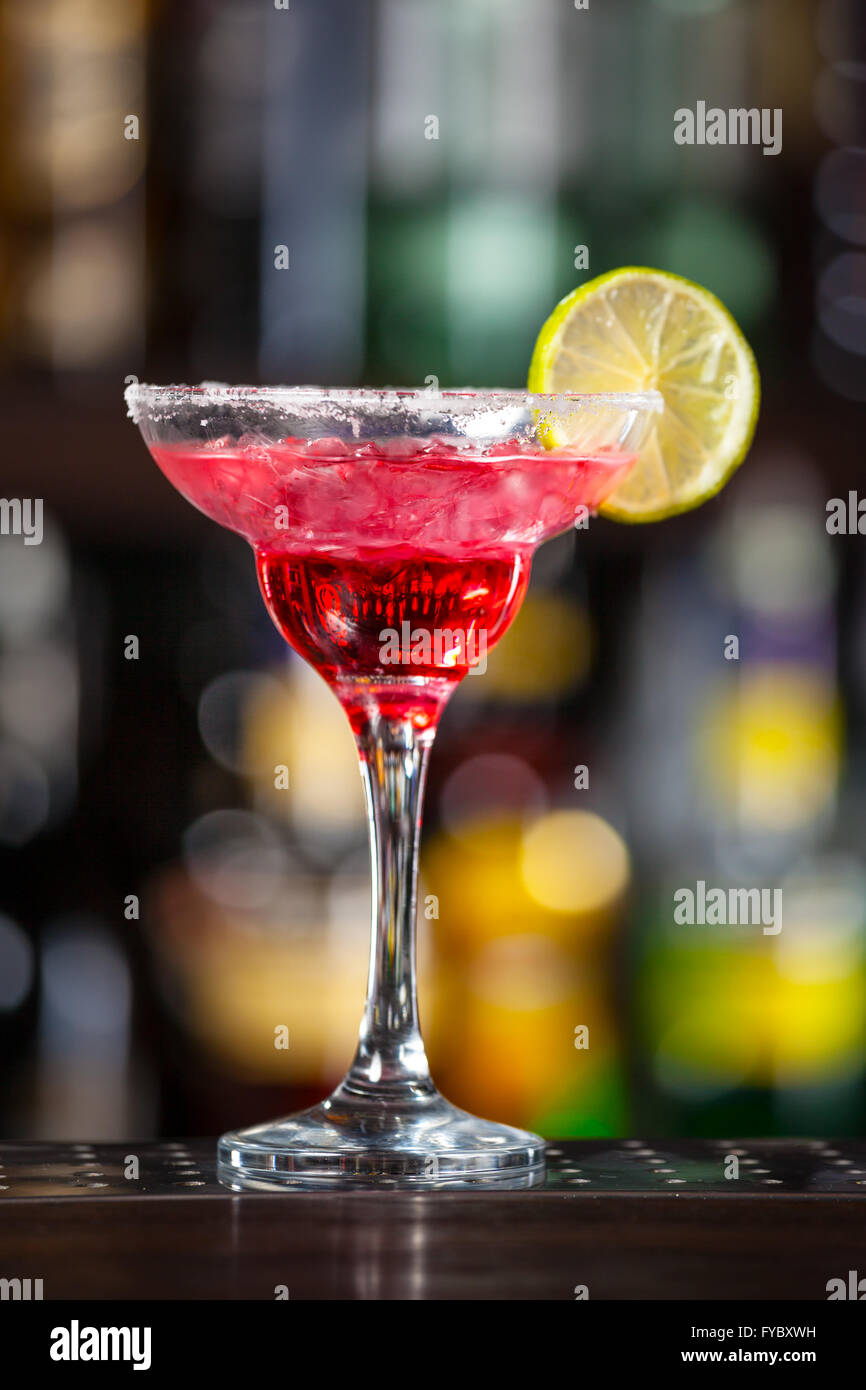 Cocktail garnished with lime standing on the bar counter Stock Photo ...