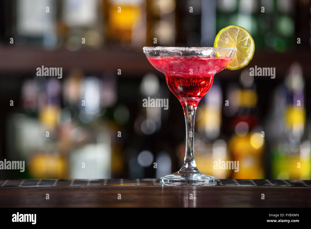 Cocktail garnished with lime standing on the bar counter Stock Photo ...