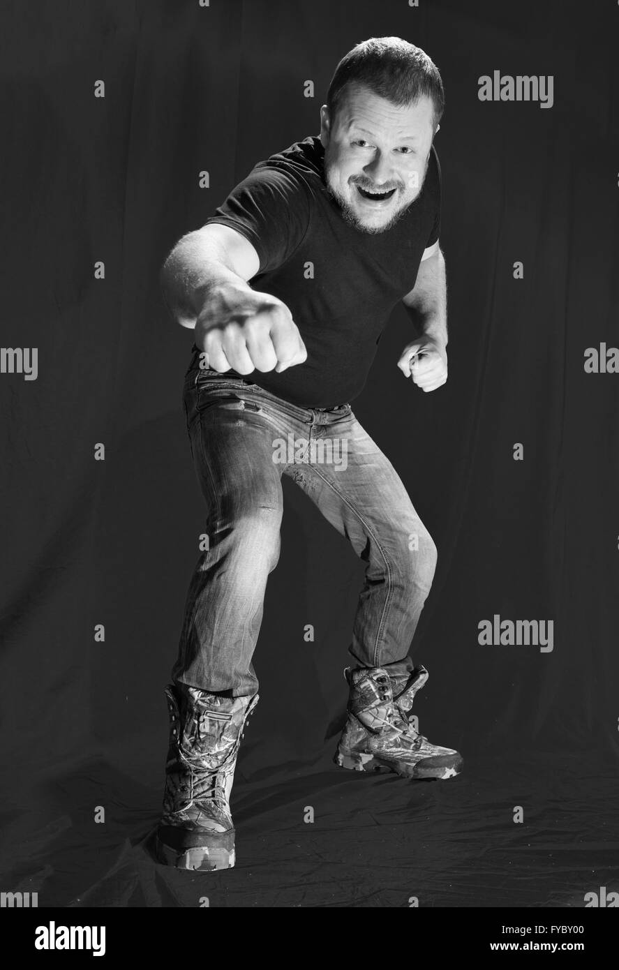 Emotional portrait of agressive bully fighting on black background ...