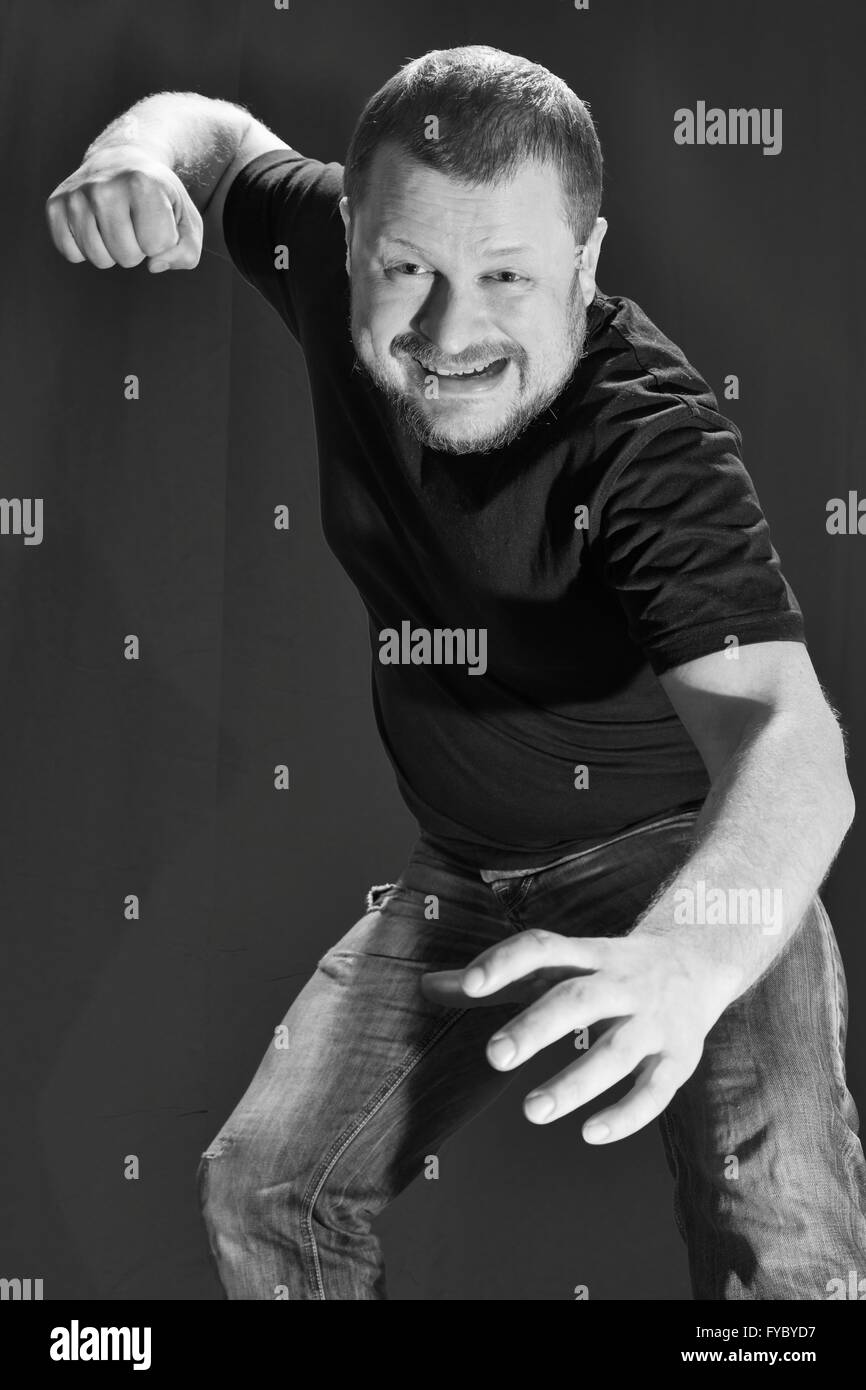 Emotional portrait of agressive bully fighting on black background ...