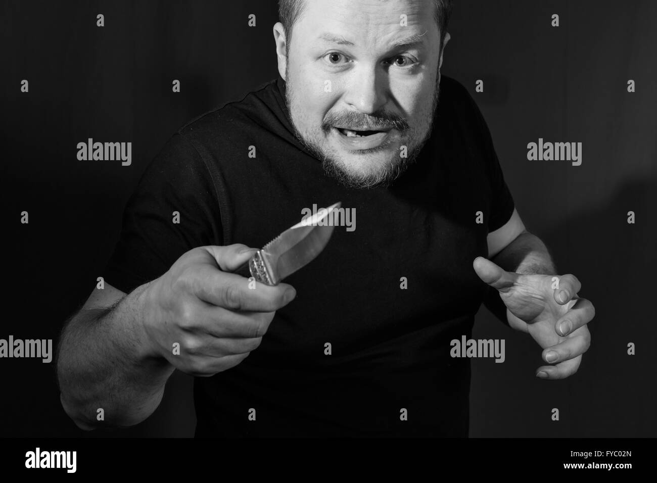 Portrait of a gangster with a knife low key Stock Photo - Alamy