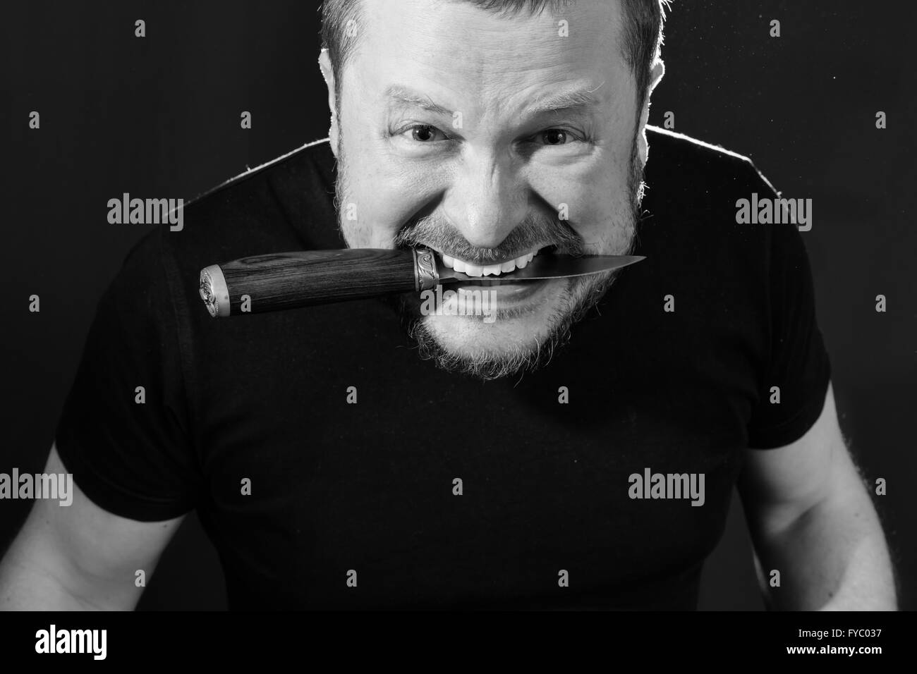 Portrait of a gangster with a knife low key Stock Photo - Alamy