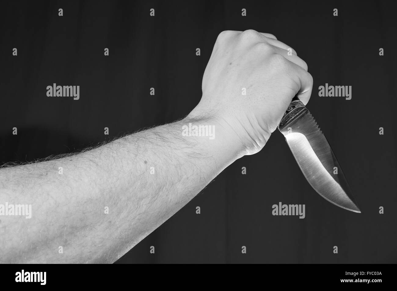 Man's hand holding knife close up view on black background Stock Photo ...