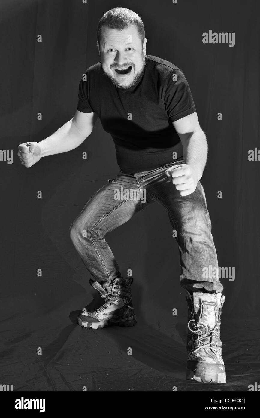 Emotional portrait of agressive bully fighting on black background ...