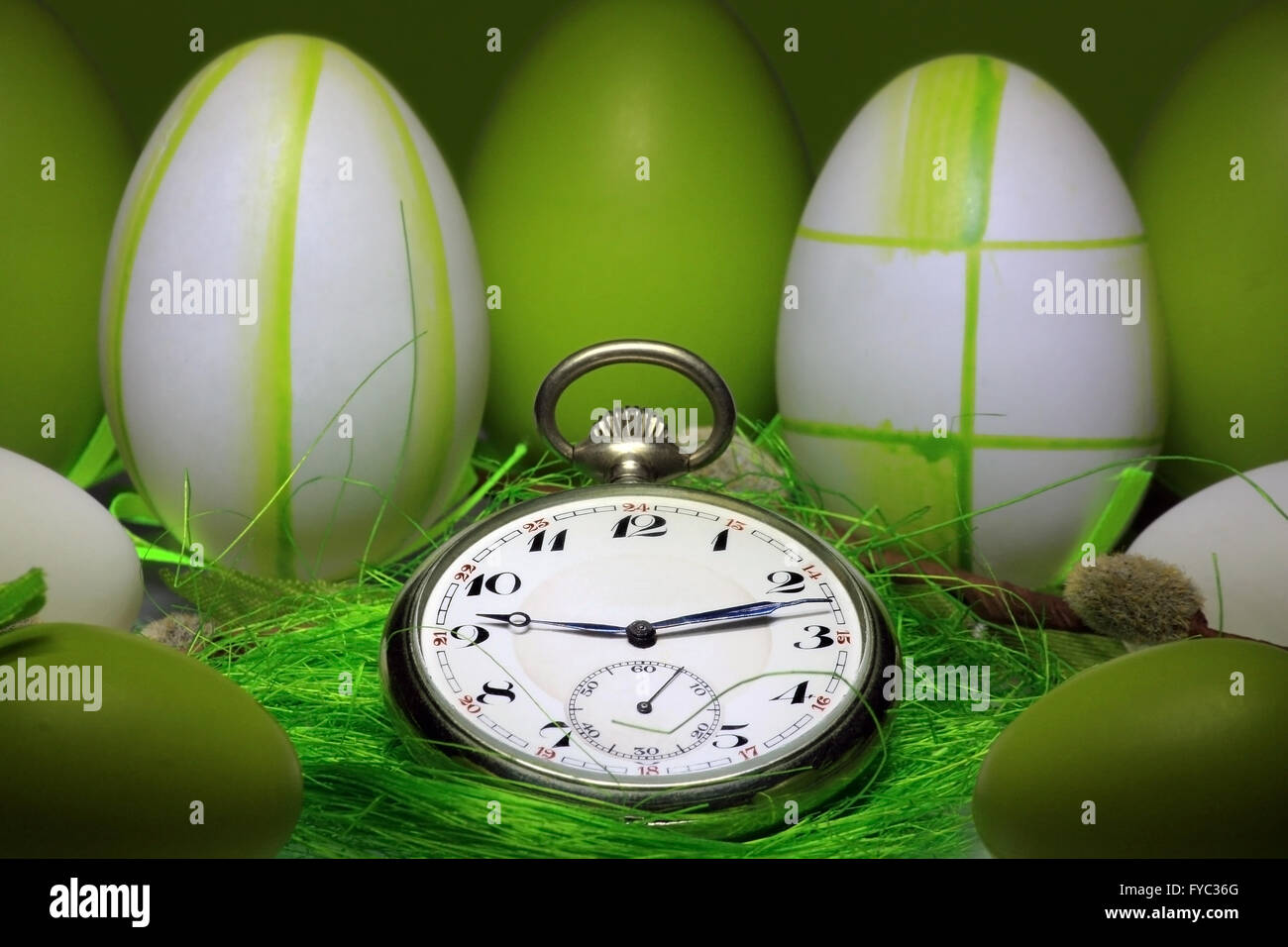 Pocket watch with easter eggs decoration on green grass Stock Photo - Alamy