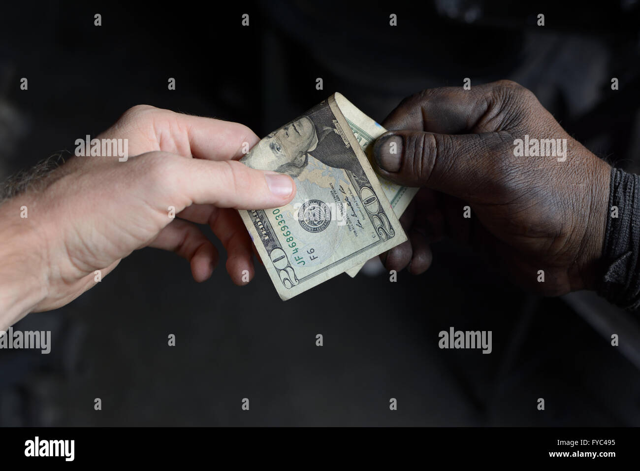 One custome hand giving money to another worker hand Stock Photo - Alamy