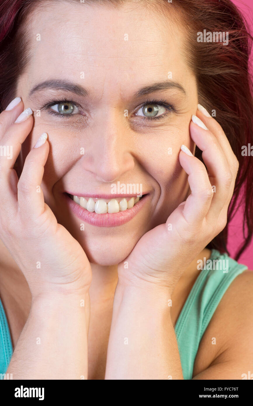 Happy woman hands on face Stock Photo - Alamy