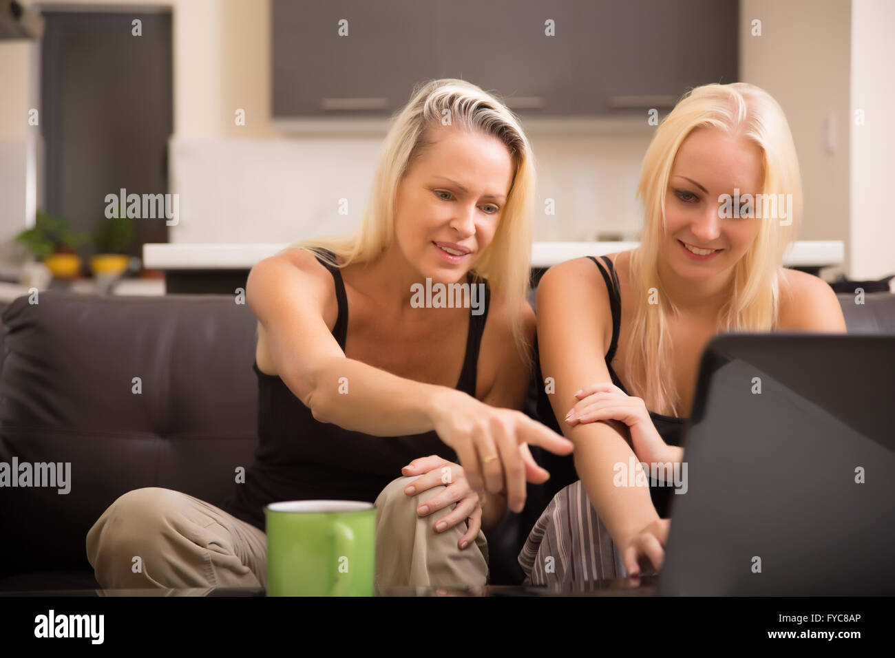 Mother and Daughter looking things up on a laptop computer Stock Photo ...