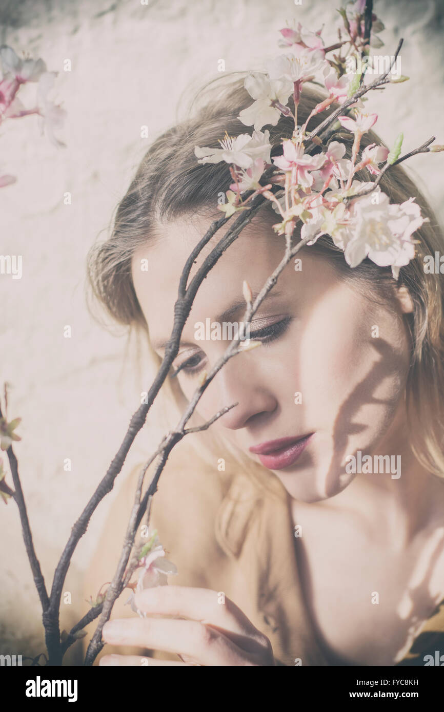 Beautiful young woman with blossoming flowers Stock Photo - Alamy
