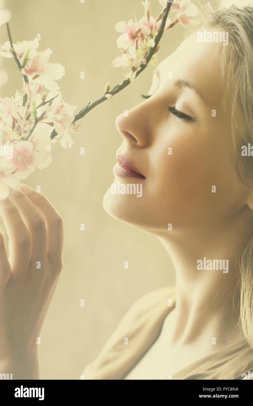Woman smelling flowers on plant hi-res stock photography and images - Alamy