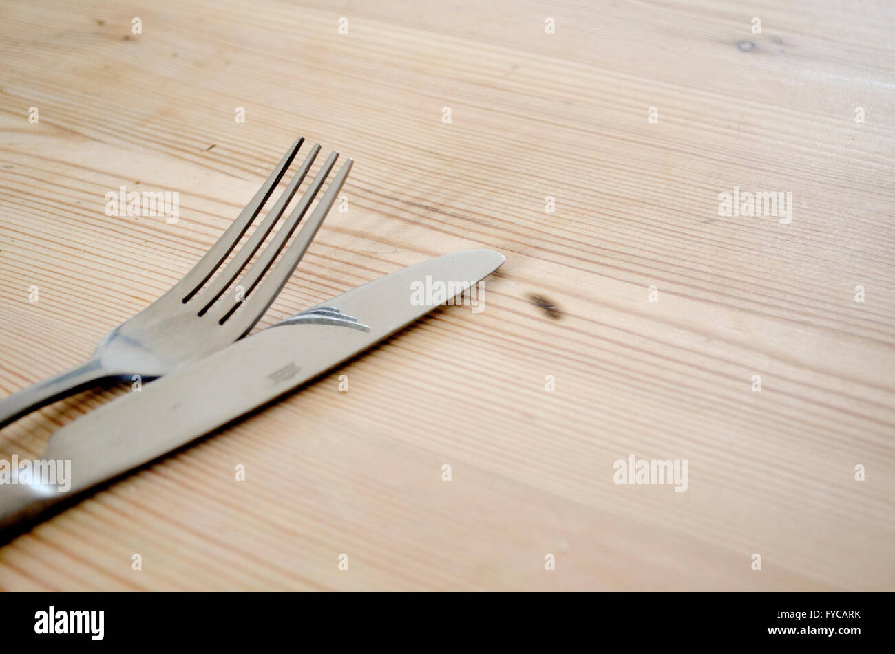 Cutlery on a wooden dining table Stock Photo - Alamy