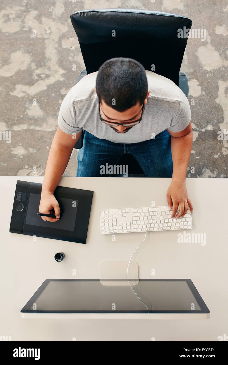 Male graphic designer using graphic tablet for design and drawing. Top ...