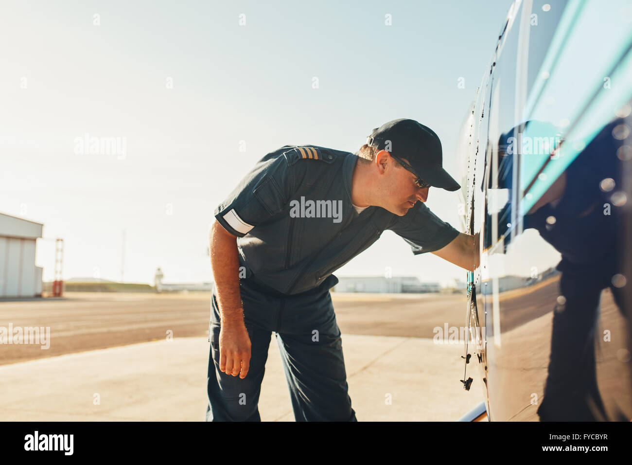 Helicopter pilot checking the engine condition of helicopter before ...