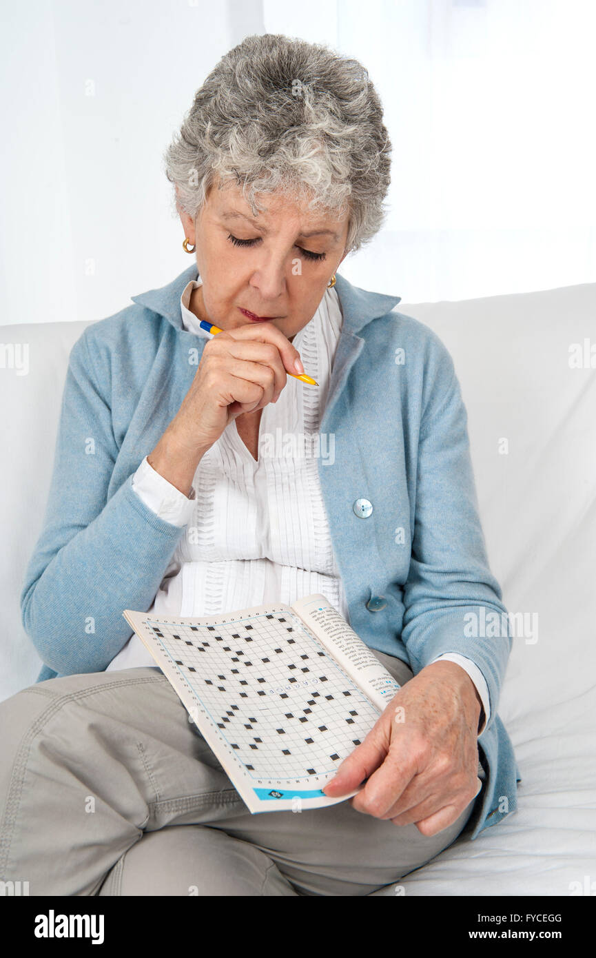 ELDERLY PERSON DOING CR-WORD PUZZLE Stock Photo - Alamy
