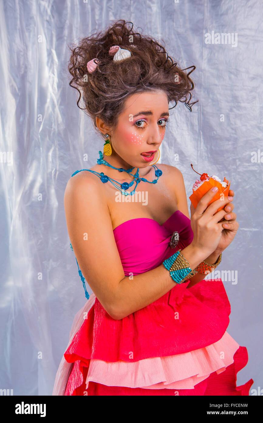 Beautiful girl in bright clothes and make up with colorful cherry ...