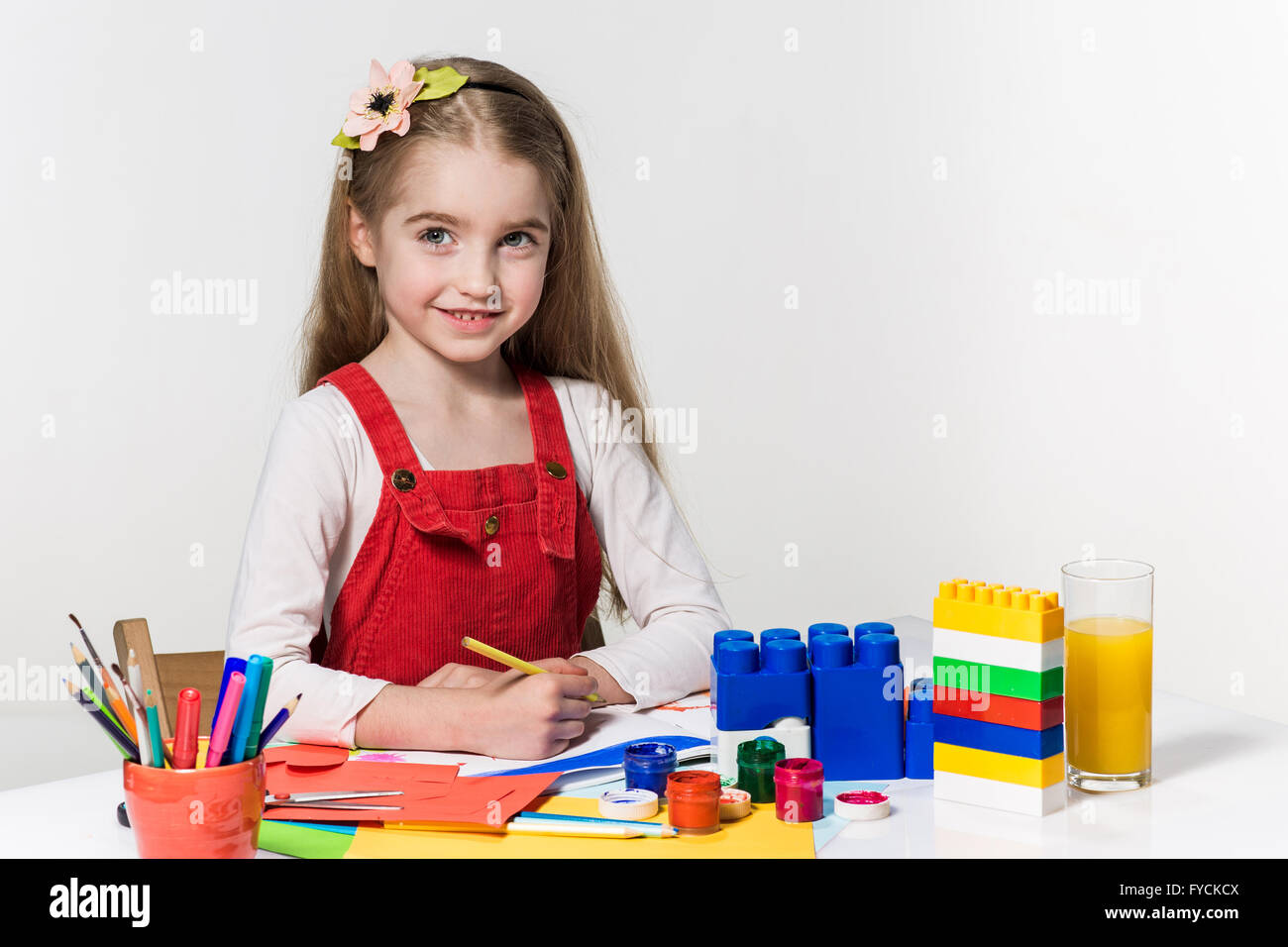 Cute little girl drawing with paint and paintbrush at home Stock Photo ...