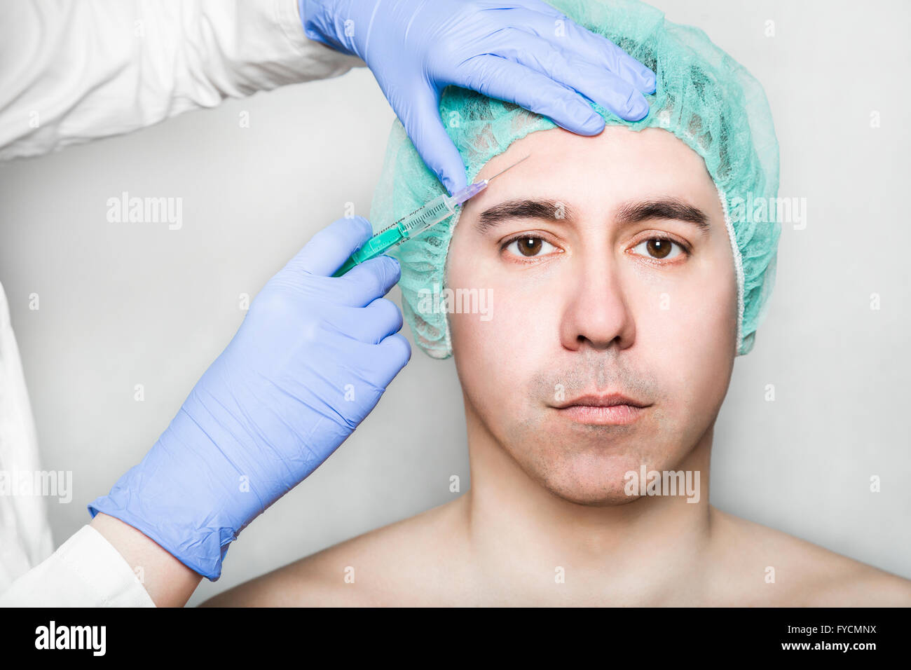 Doctor aesthetician makes face beauty injections to male patient Stock ...