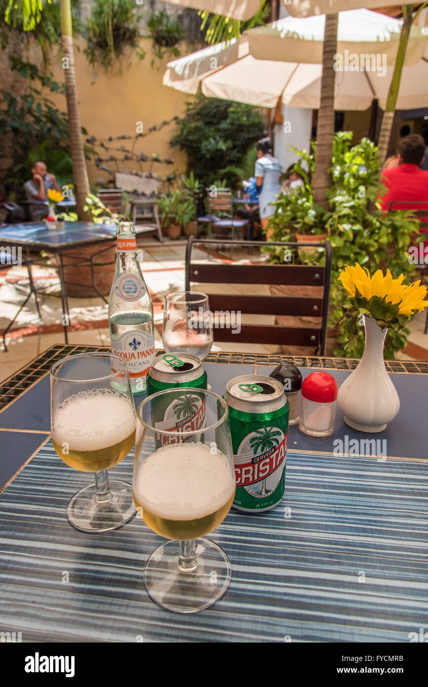 Refreshing glasses of local Cuban beer 'Cristal'. A pretty garden full ...