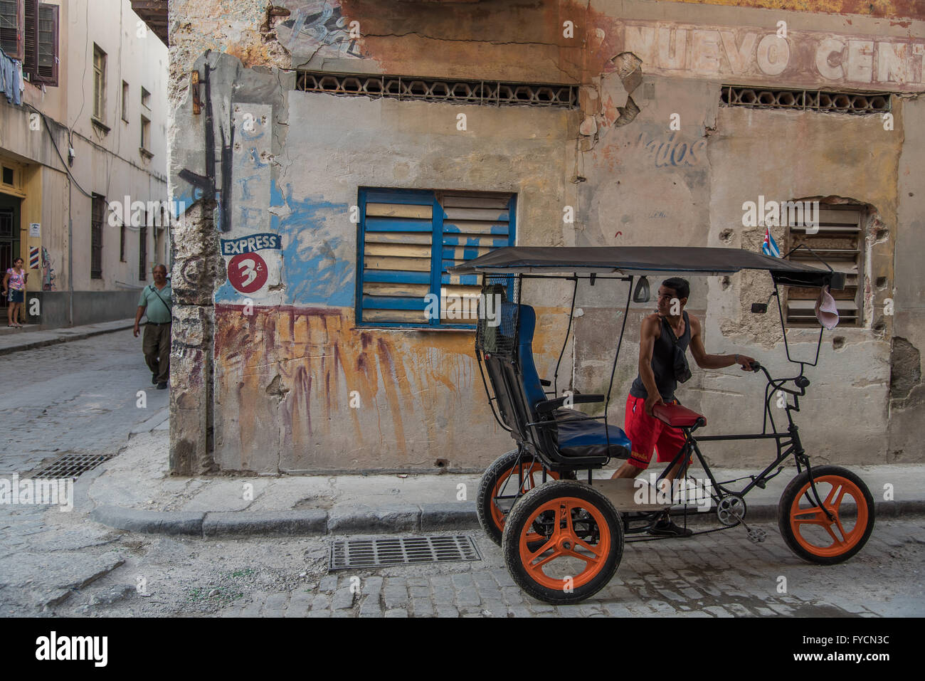 A typical Havana scene. Cycle rickshaw against a very Cuban backdrop of ...