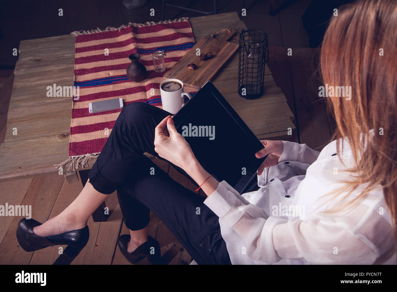Beautiful girl working behind the plate at the table . Brick background ...