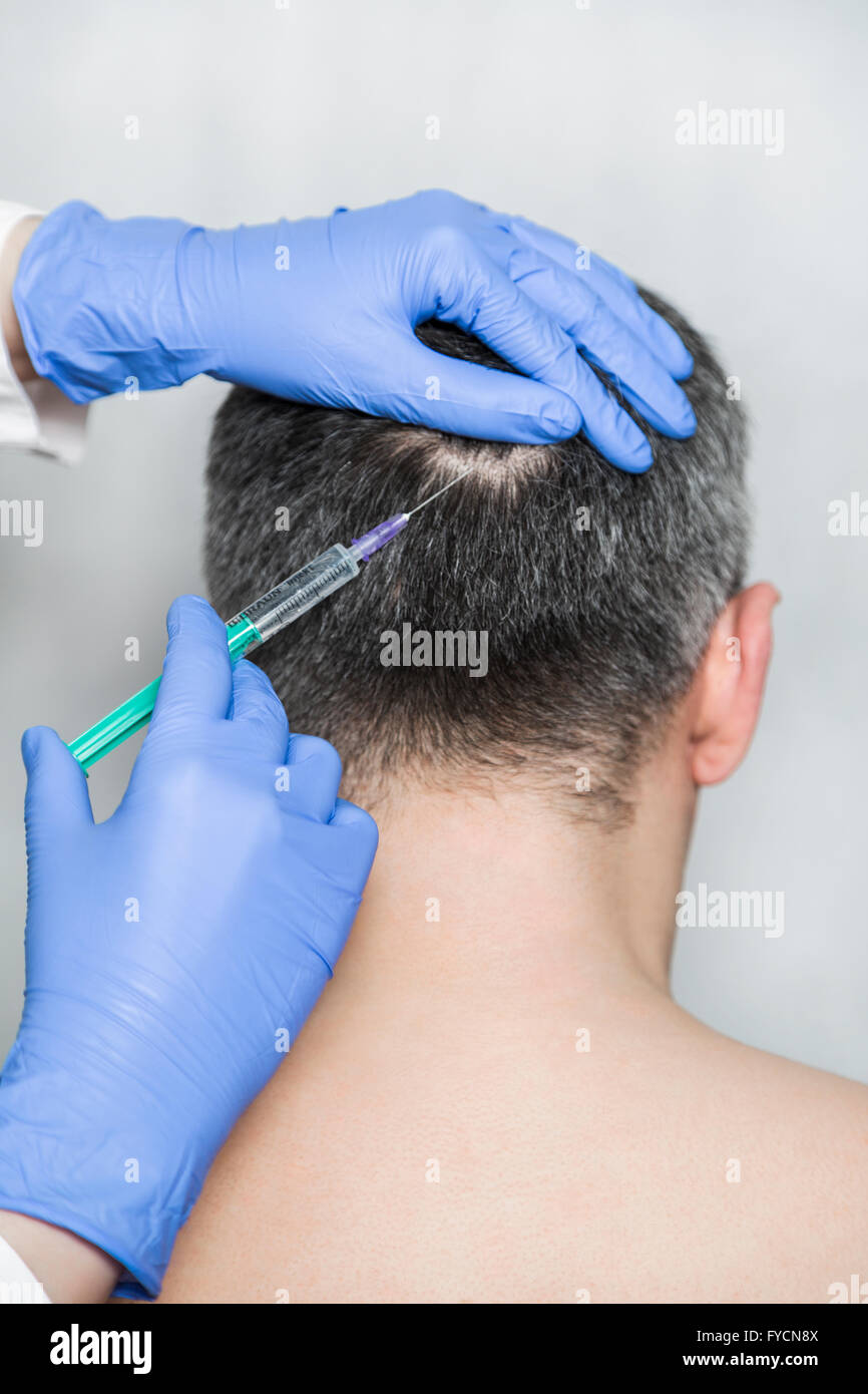 Doctor aesthetician makes head beauty injections to male patient Stock ...