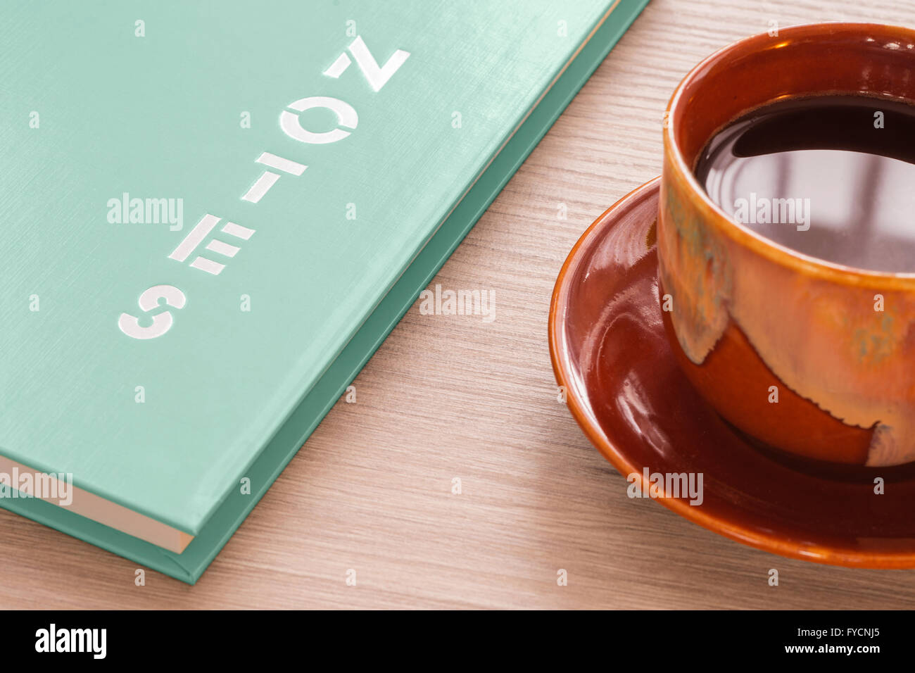 Coffee cup and notebook on wood desk Stock Photo - Alamy