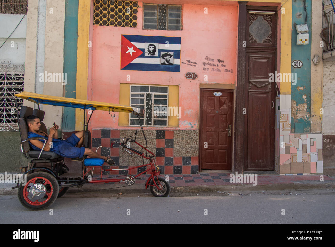 A typical Havana scene. Cycle rickshaw against a very Cuban backdrop of ...