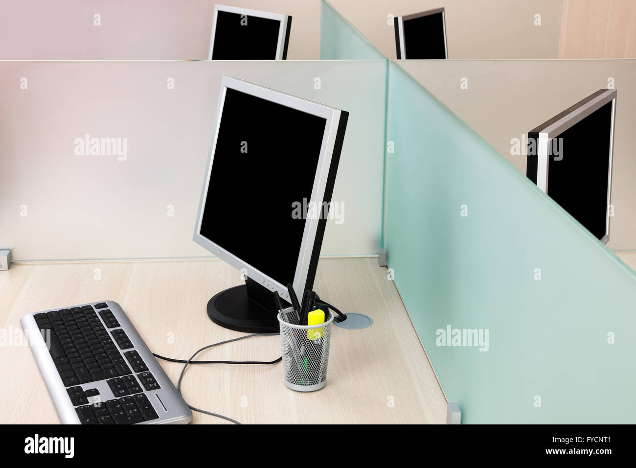 computers on a desk in a modern office Stock Photo - Alamy