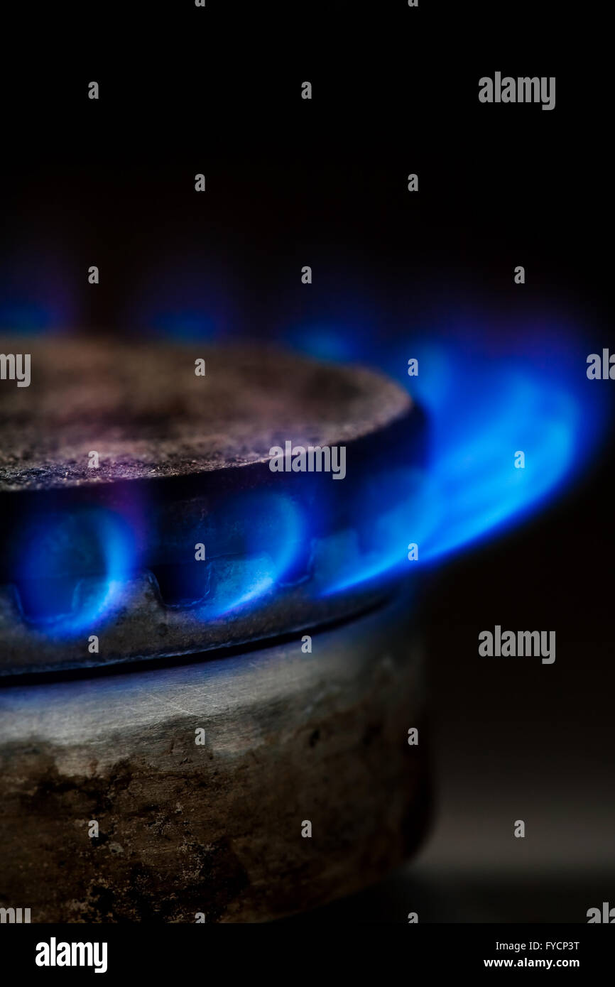 Gas burning by a dark blue flame on kitchen Stock Photo - Alamy
