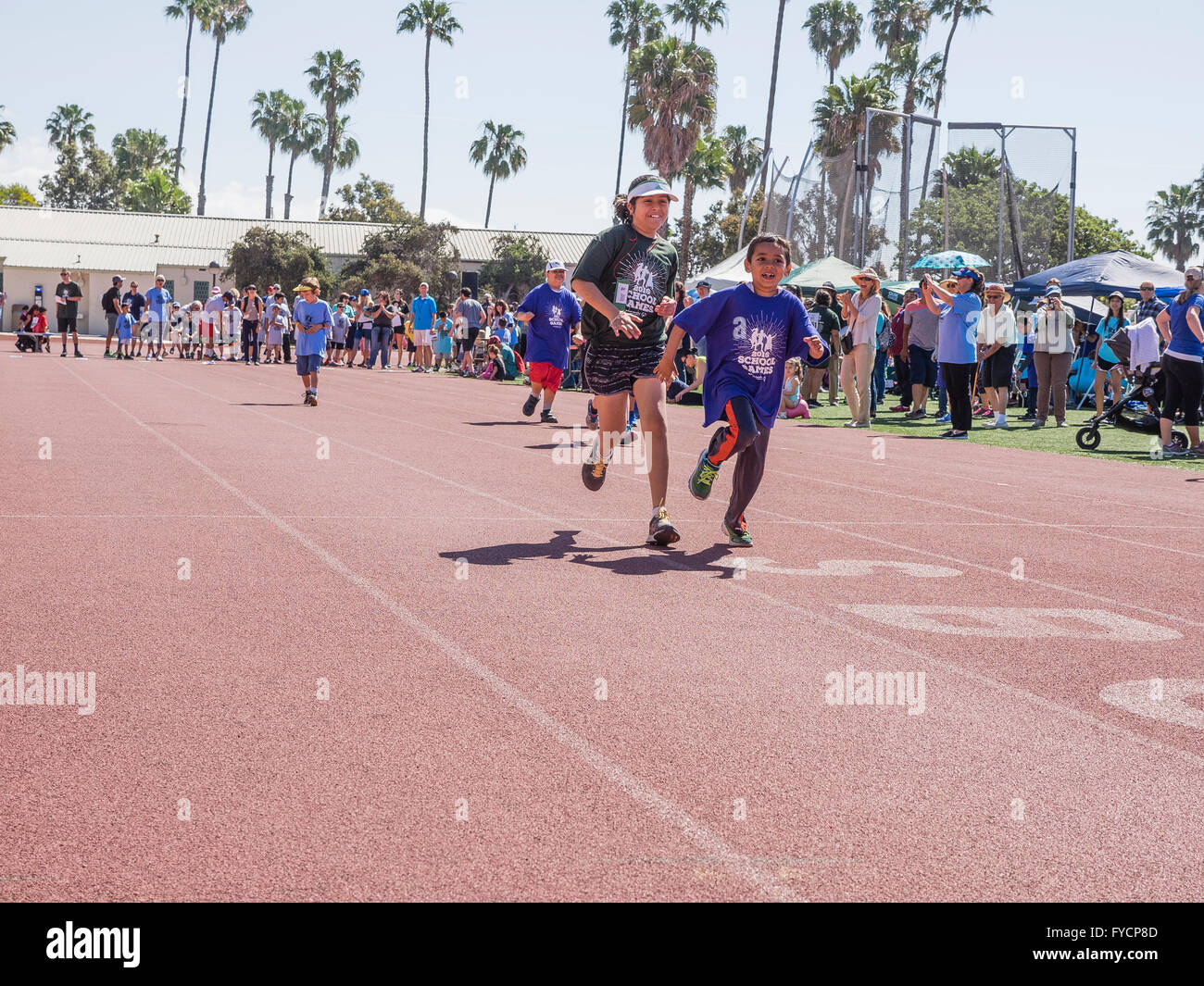 Volunteers help disabled elementary school kids race in the 50 meter ...
