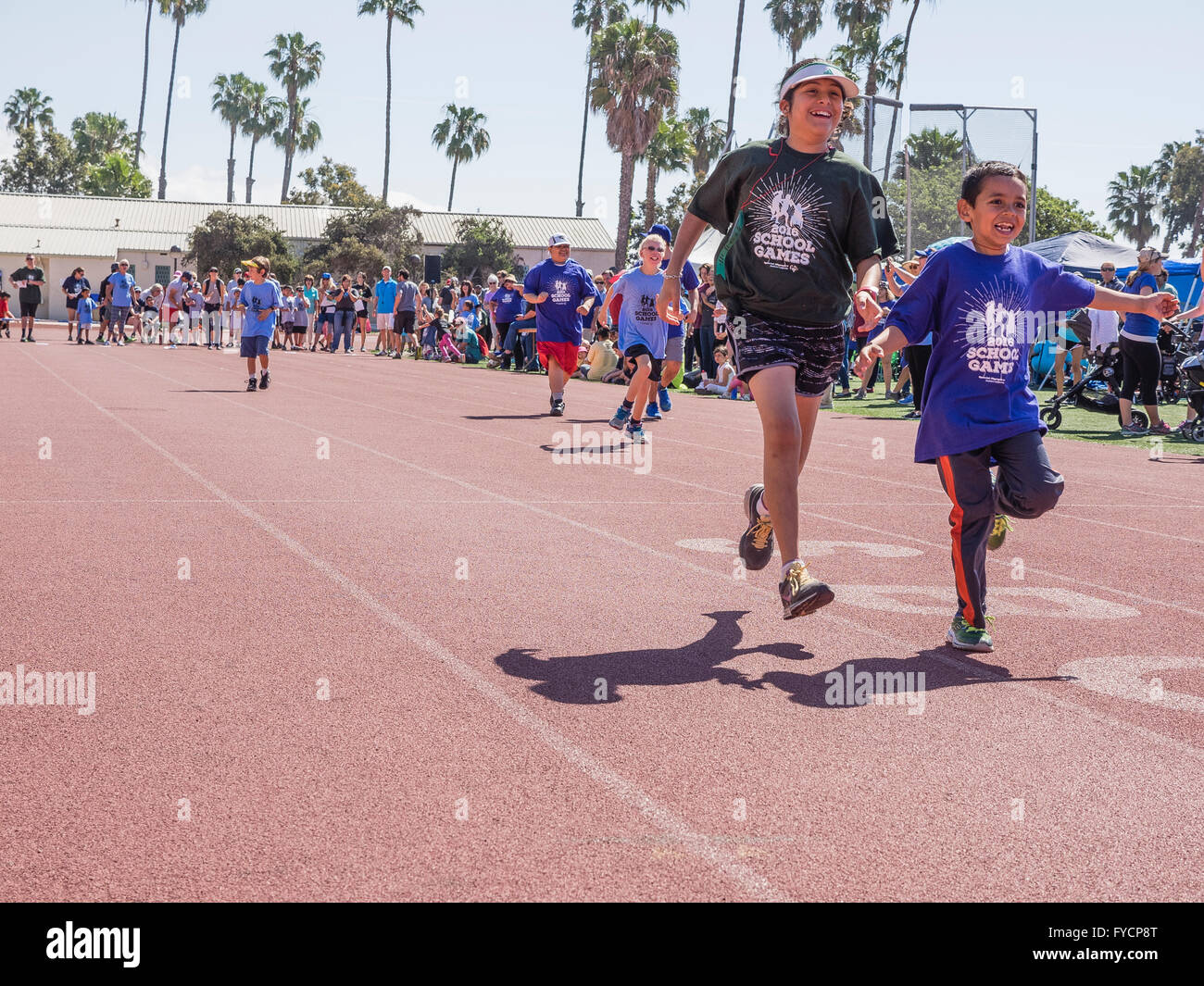 Volunteers help disabled elementary school kids race in the 50 meter ...