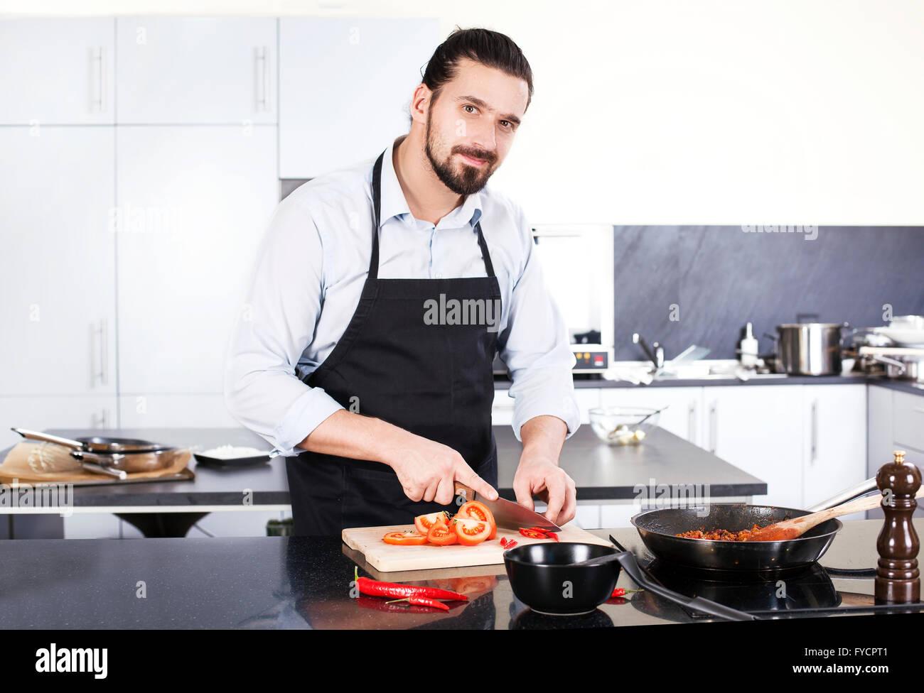 Chef preparing dishes in a frying pan Stock Photo - Alamy