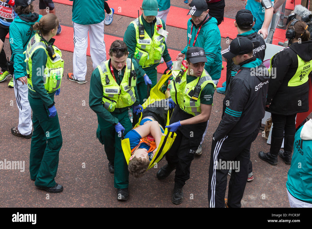 London, UK. 24 April 2016. Medics from St John Ambulance help a runner ...