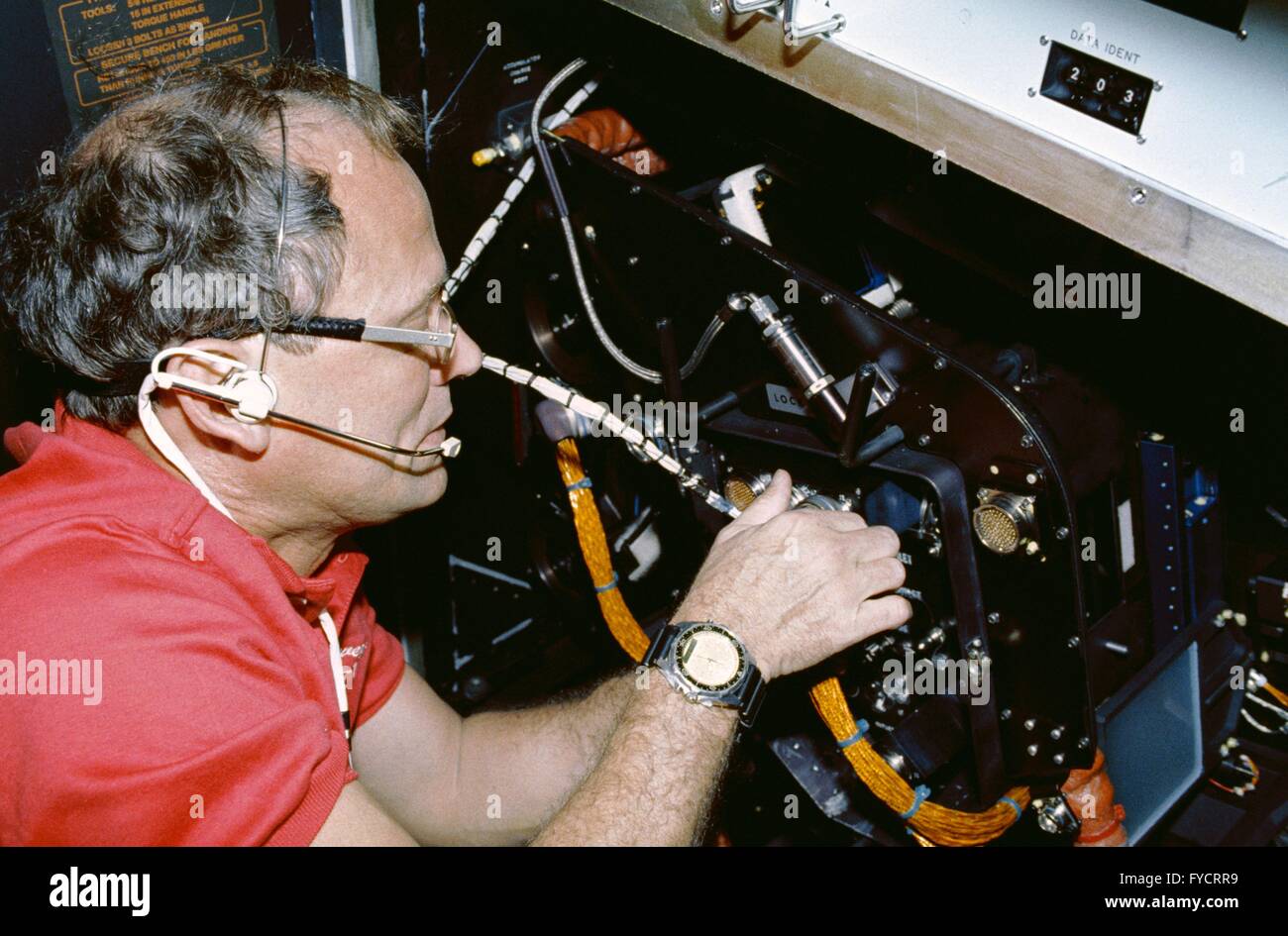 NASA astronaut Norm Thagard performs the Fluids Experiment System in ...
