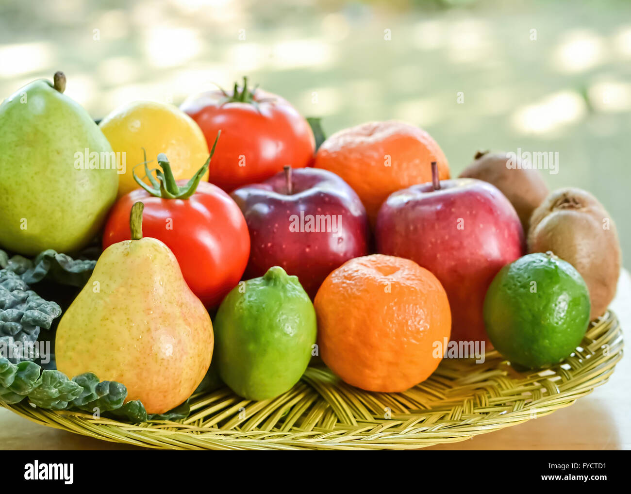 Closeup of fruits and kale on green woven basket Stock Photo - Alamy