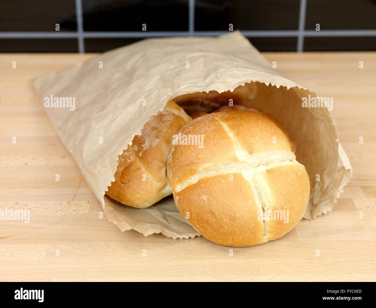 Fresh bread rolls isolated on a kitchen bench Stock Photo - Alamy