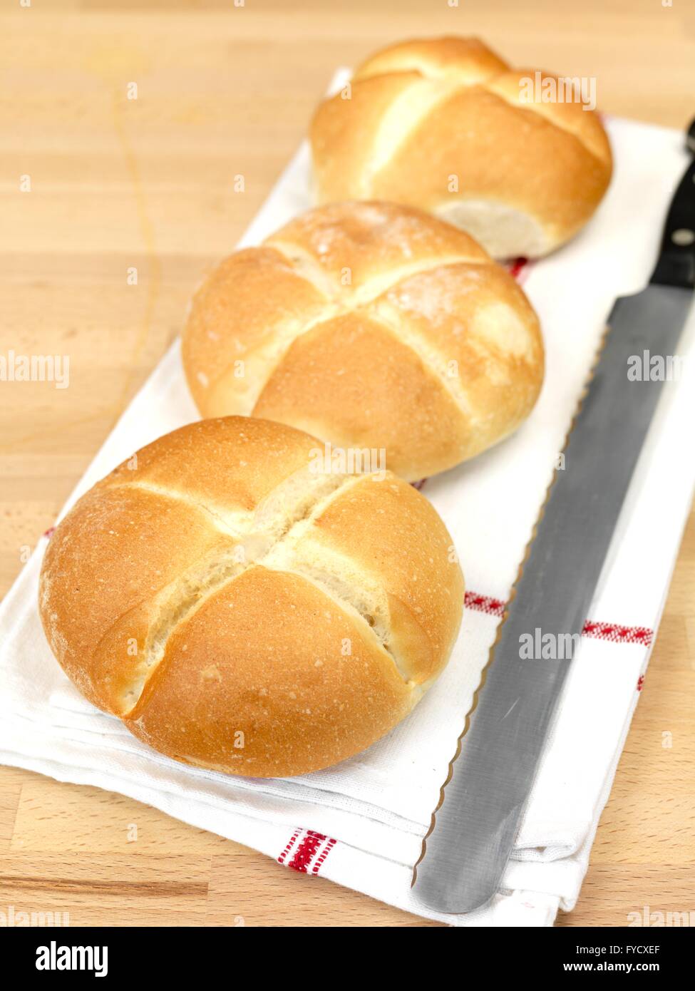 Fresh bread rolls isolated on a kitchen bench Stock Photo - Alamy