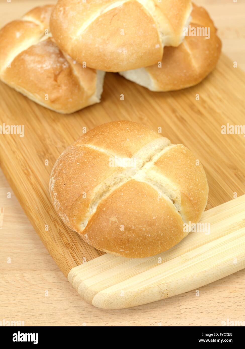 Fresh bread rolls isolated on a kitchen bench Stock Photo - Alamy