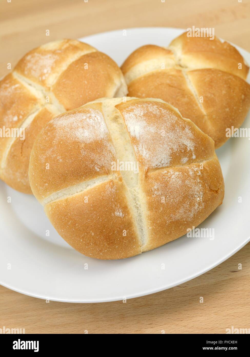 Fresh bread rolls isolated on a kitchen bench Stock Photo - Alamy