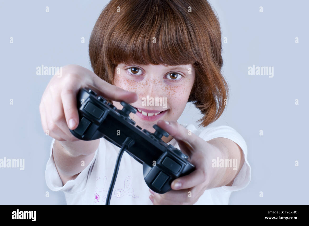 Picture of a young with freckles playing games Stock Photo - Alamy