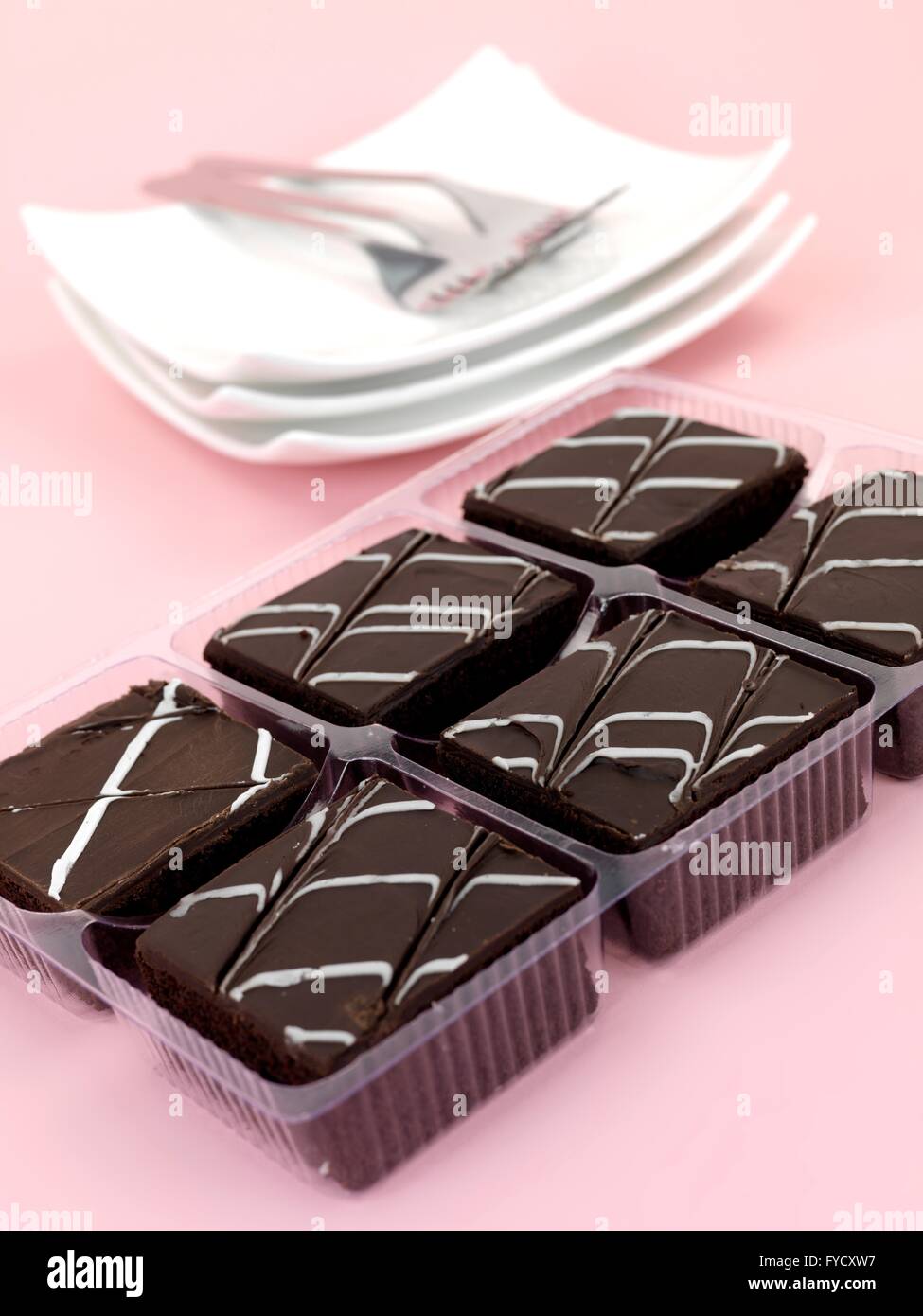 Chocolate mud cake slices isolated against a pink background Stock ...