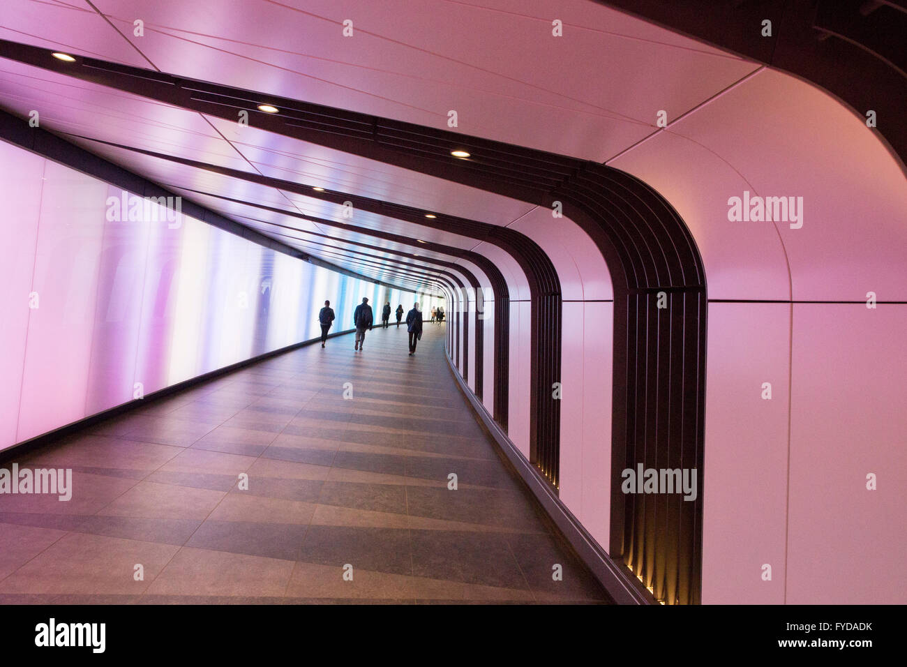 Commuters traveling up the escalator at King's Cross station, London ...