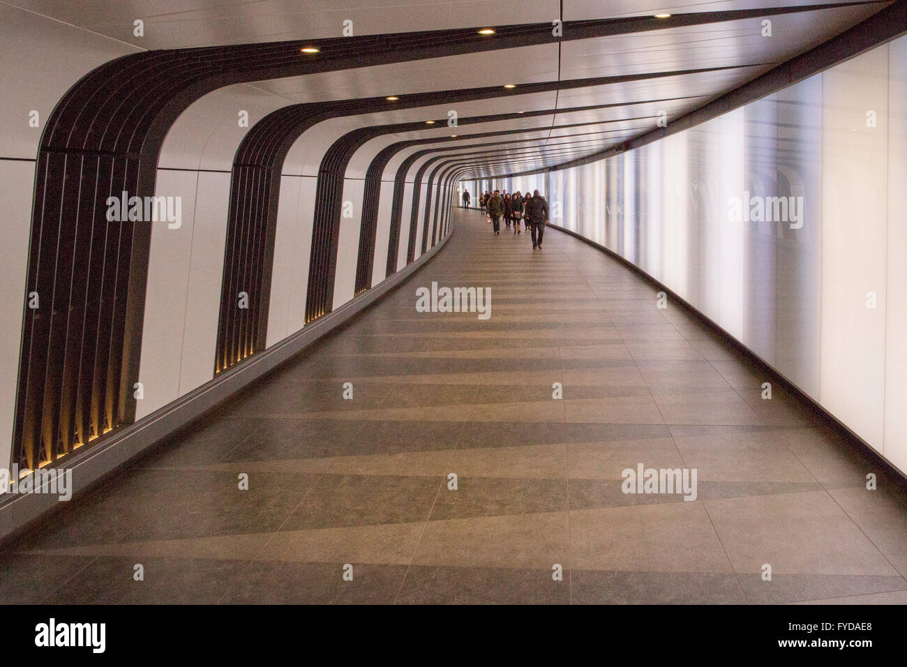 Commuters traveling up the escalator at King's Cross station, London ...