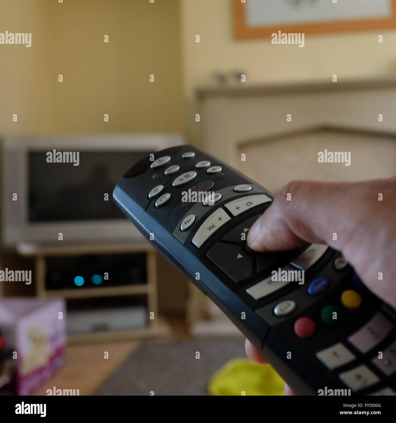 using TV remote Stock Photo - Alamy