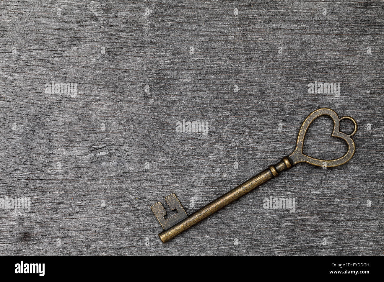 golden heart shaped vintage key on grunge wooden background Stock Photo ...