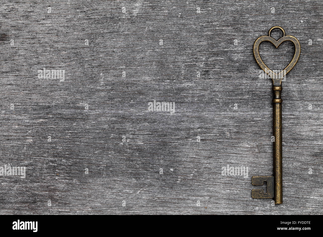 heart shaped vintage key on grunge wooden background Stock Photo - Alamy