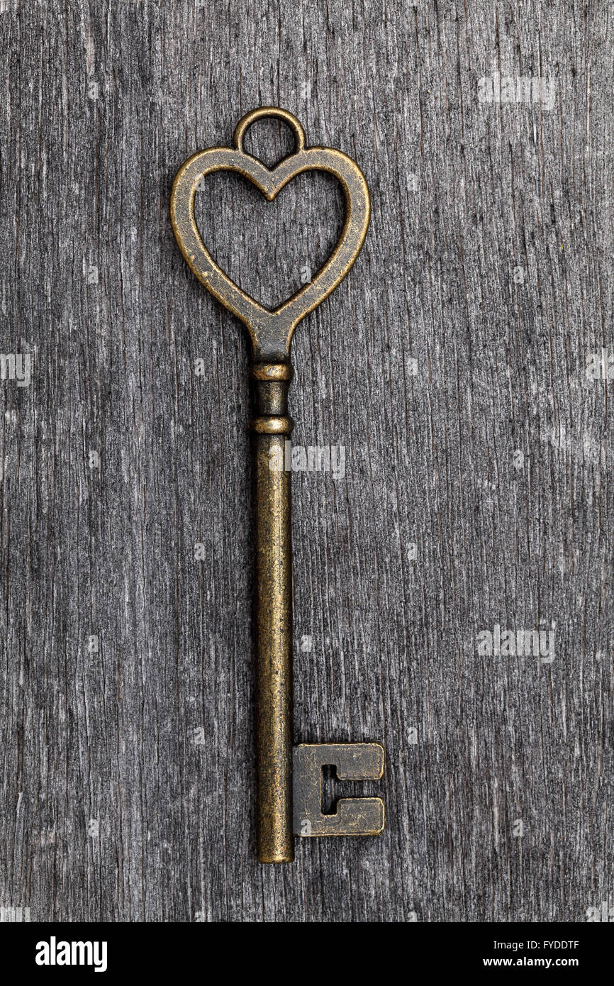 heart shaped vintage key on grunge wooden background Stock Photo - Alamy