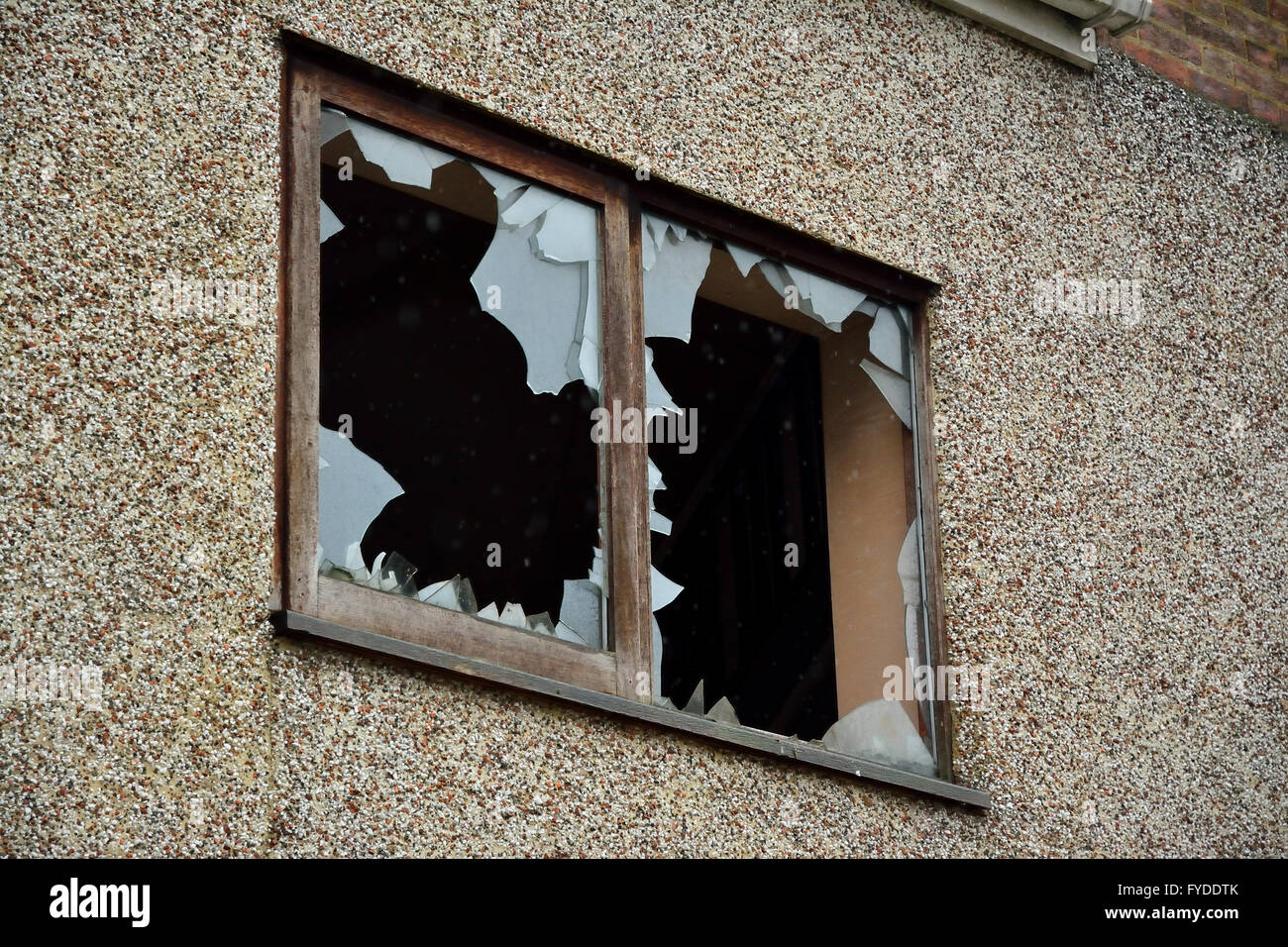 Broken window caused by vandalism and rain getting in Stock Photo - Alamy