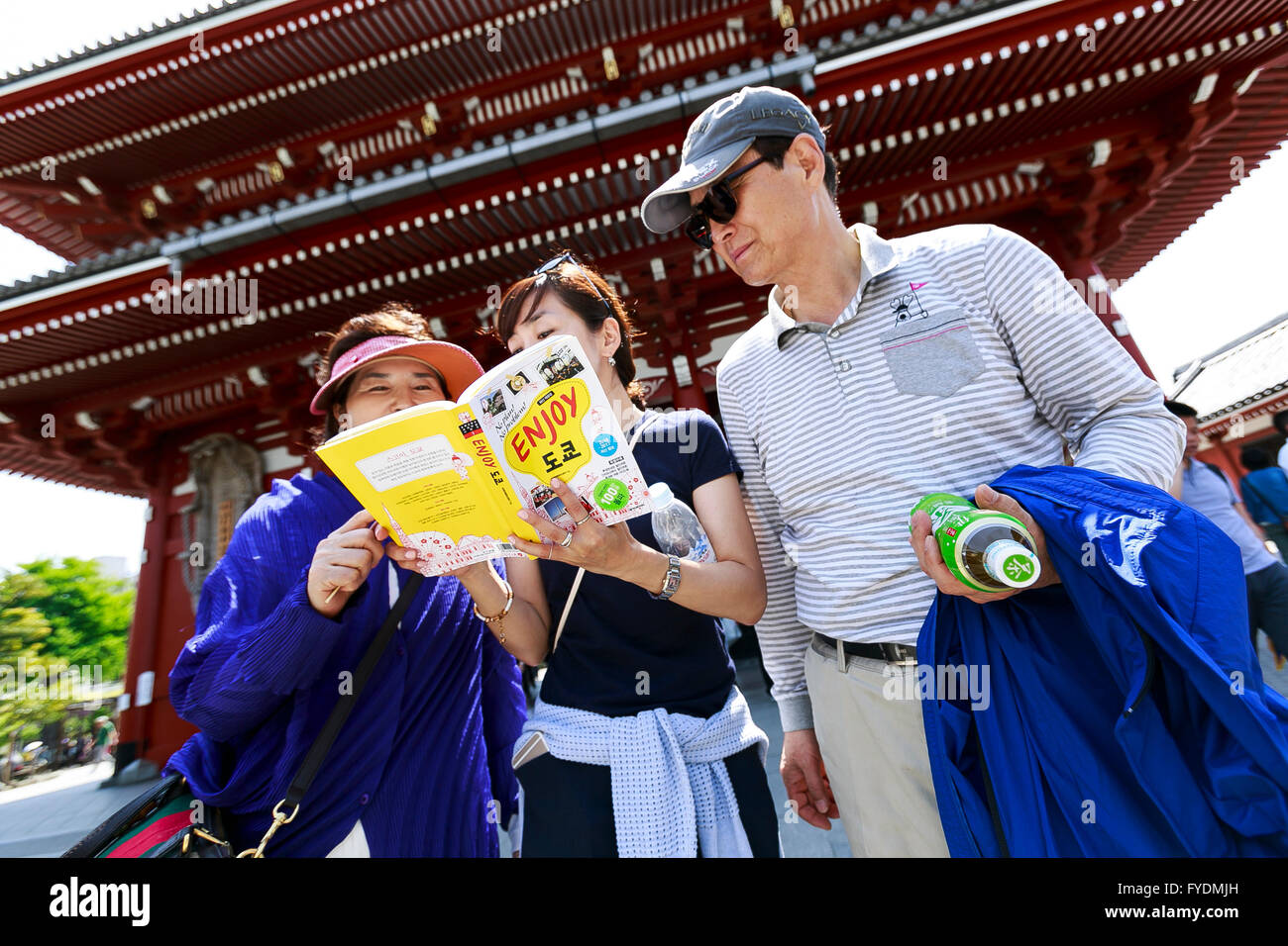 Foreign tourists consult a Tokyo guide map at the Sensoji Temple in ...